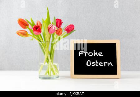 colorful tulips with chalkboard and orange background with german text ...