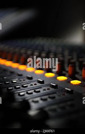 A vertical closeup of the soundboard buttons glowing in the darkness ...