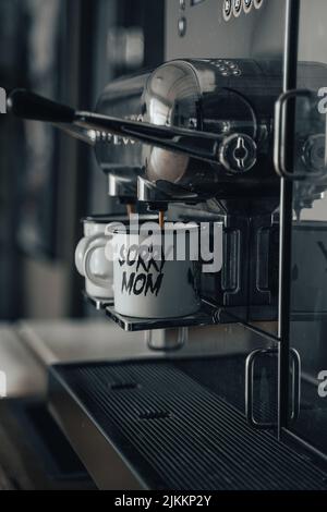 two espresso cups under coffee engine Stock Photo - Alamy