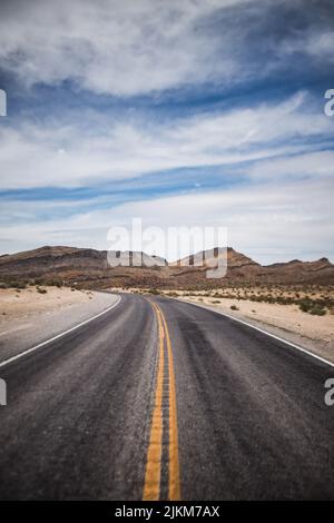 A vertical shot of rocky mountains under a blue sky in the countryside ...