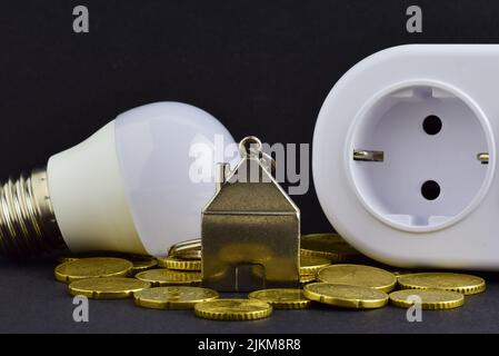 The golden coins and a plug isolated on a black background Stock Photo ...