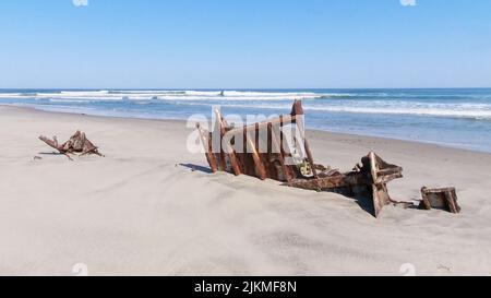 A serene view of scrap metal remains on Skeleton Coast, Namibia Stock ...