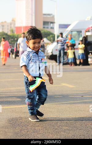 Boy running with Indian flag in a field Stock Photo - Alamy