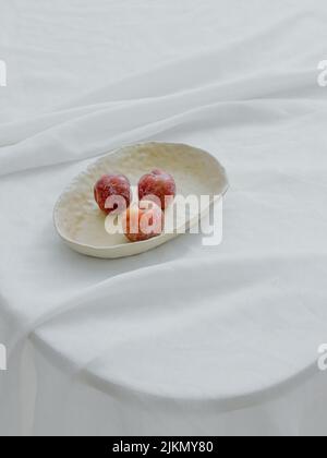 Red apples in white fabric reusable bag placed on wooden table. Eco ...