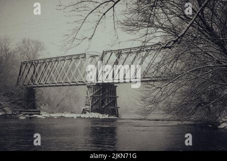A grayscale shot of a bridge over the river Stock Photo - Alamy