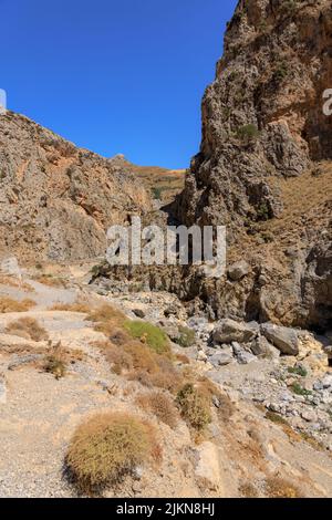 A vertical shot of rocky mountains under cloudy sky Stock Photo - Alamy