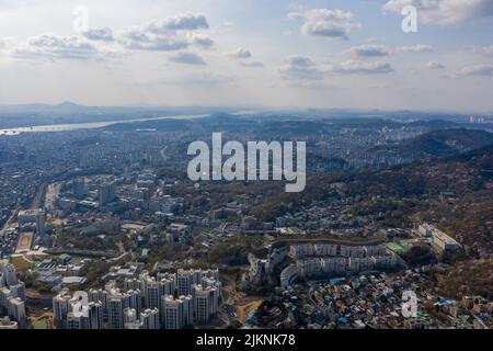 An aerial cityscape of Seoul surrounded by buildings in background of ...