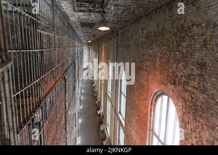 A long corridor in a wethered prison with rusty walls Stock Photo - Alamy