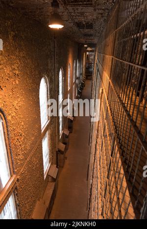 A long corridor in a wethered prison with rusty walls Stock Photo - Alamy