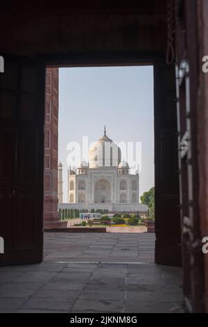 A vertical shot of the Taj Mahal Mausoleum under the blue sky, Agra ...