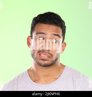 I dunno... a handsome young man making a face against a green ...