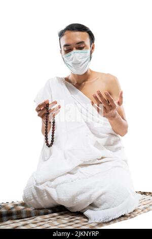 Male wearing mask and praying for allah to protect him from diseases ...