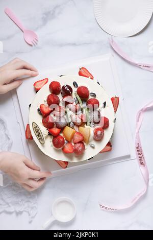A vertical shot of a beautiful birthday cake with strawberry ...