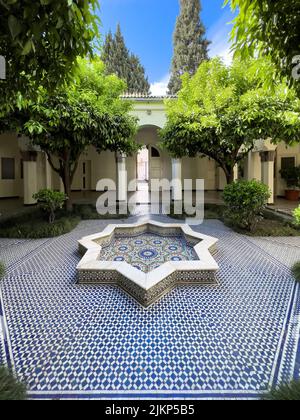 Empty mosaic courtyard with a small fountain in the middle Stock Photo ...