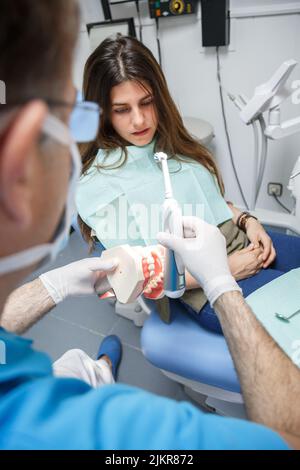 Professional doctor demonstration process of healthy teeth brushing to ...