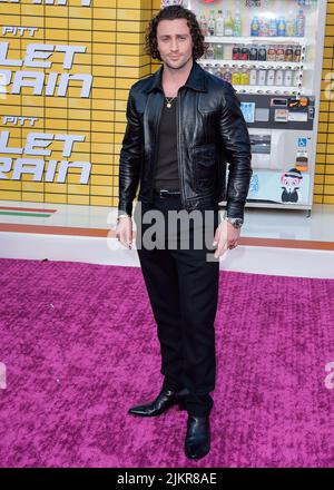 Wearing a black leather jacket, gold scarf and jeans, "Coronation ...