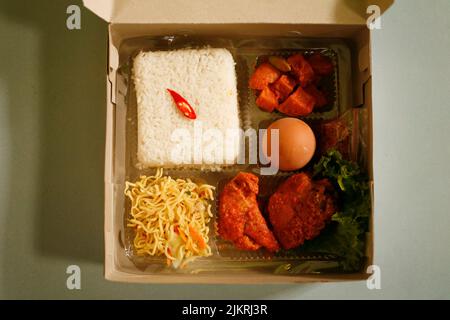 Rice Box or Indonesian lunch box with chicken meat, tofu, spicy potato ...
