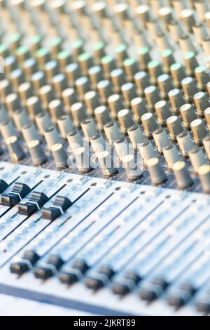 Music producer learning to use mixing console and soundboard, using ...