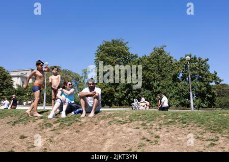 People cool off at Trocadero fountain near the Eiffel Tower during a ...