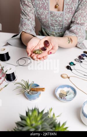 Artisan woman making handmade accessory and taking photo for media ...