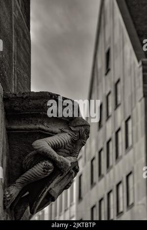 A grayscale of a statue on a building wall Stock Photo - Alamy