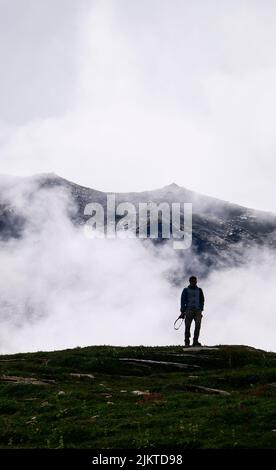 Vertical shot of a person hiking in the mountains during winter Stock ...