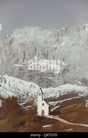 Vertical shot of cliffs covered in the fog under the sunlight and a ...