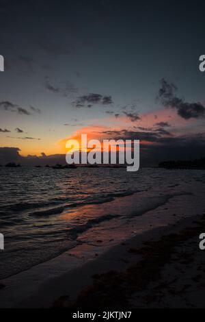 A mesmerizing sunset over the waves of the sea Stock Photo - Alamy