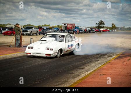 Funny car dragster doing a burnout with smoke before drag race. Burnout ...