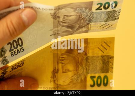 200 Reais, Brazilian money reflected in a golden mirror Stock Photo - Alamy