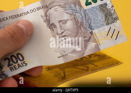 200 Reais, Brazilian money reflected in a golden mirror Stock Photo - Alamy