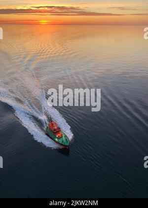 pilot boat in the harbor at sunset Stock Photo - Alamy