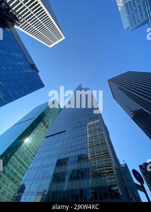A vertical shot of high blue skyscrapers in Chicago in cloudy sky ...