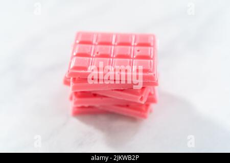 Stack of homemade mini pink chocolates on the counter Stock Photo - Alamy