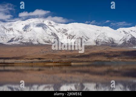 A mesmerizing view of beautiful snow-capped mountains under a cloudy ...