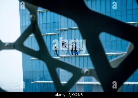 A number of men cleaning the windows of towers in Doha, Qatar Stock ...