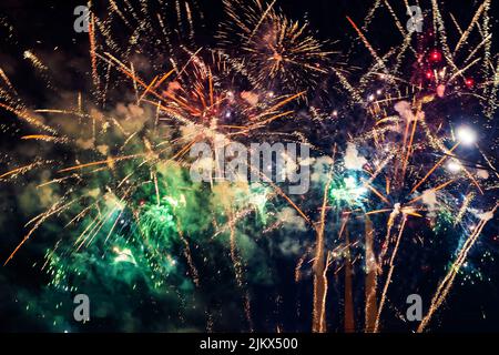 Beautiful multi-colored fireworks against the background of the night ...