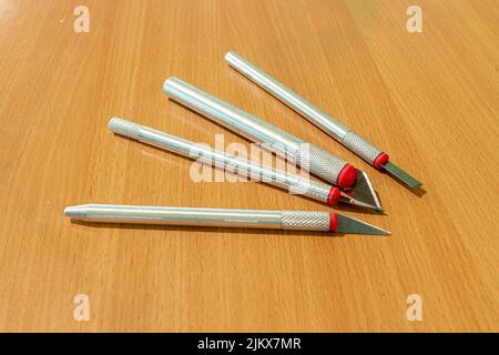 Various sharp precision craft knives with different blades in a ...