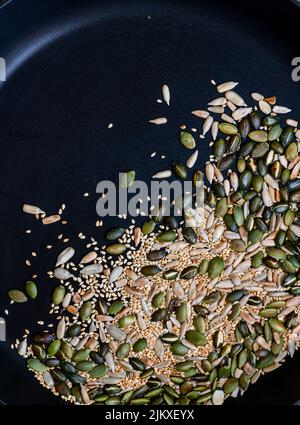Organic Toasted Sesame Seeds in a Heart Shape on wooden cooking board ...