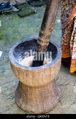 Pesting beans in a Ukhal musal (Mortal and Pestle) also known as Gail ...
