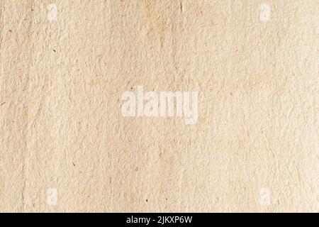 A macro focus shot of an old handmade paper texture in bright light ...