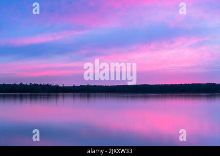 A scenic view of beautiful dusk visible on the horizon of the beach ...