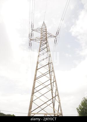Low-angle shot of power lines against the cloudy sky Stock Photo - Alamy
