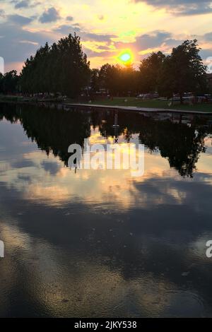 Lakeshore with a resort and mooring at sunset Stock Photo - Alamy