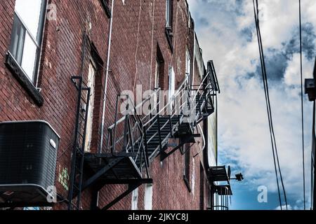 Low angle shot of fire escape stairs on the side of the building Stock ...