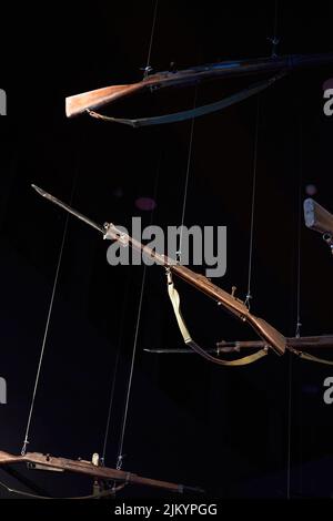 Vintage assault rifle hanging from the ceiling Stock Photo - Alamy
