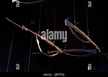 Vintage assault rifle hanging from the ceiling Stock Photo - Alamy