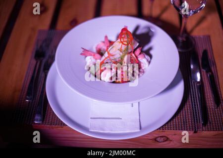 Seafood salad on a while glossy plate Stock Photo - Alamy