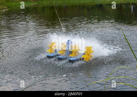 Rotary aerators used in large fish ponds Stock Photo - Alamy