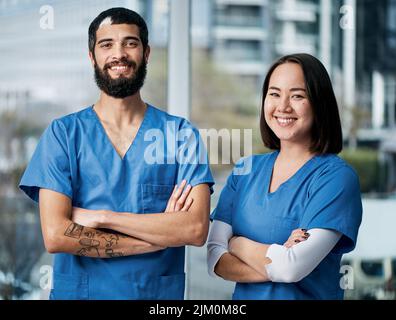Working together to save lives. two medical practitioners shaking hands ...
